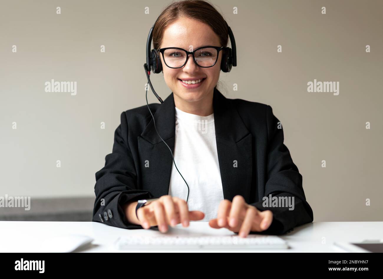 Worker customer service online center woman in headset smiling typing ...