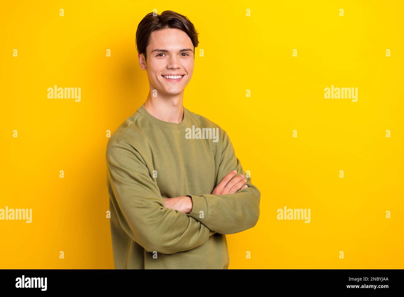 Portrait of cheerful half turned person crossed arms empty space ad ...