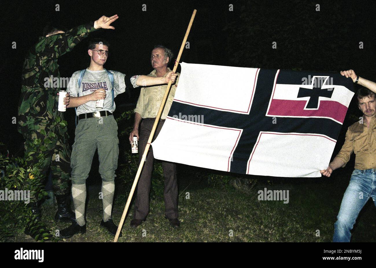 Right wing demonstrators give fascist salute when holding flag of ...