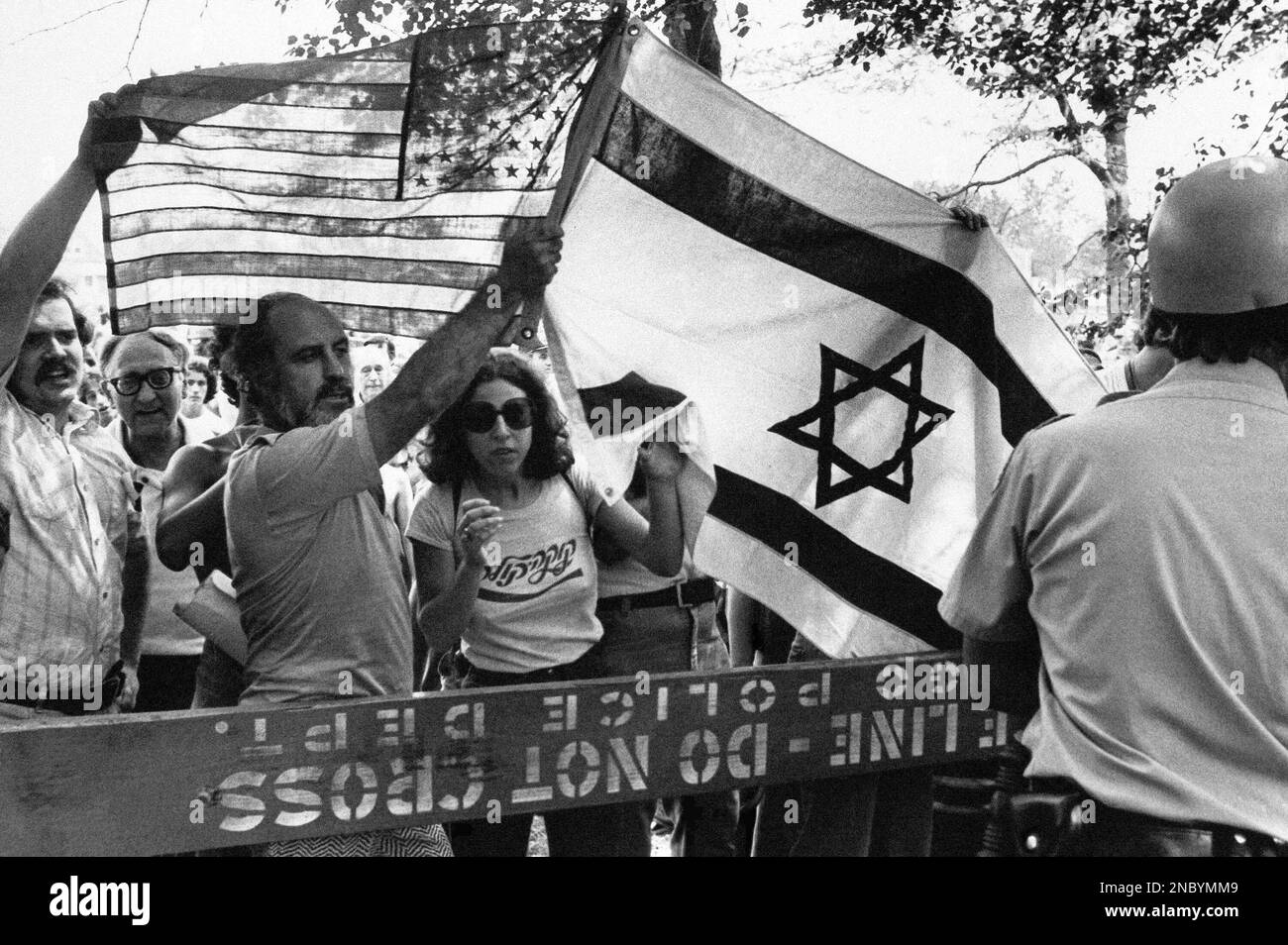 Anti-Nazi protesters wave flags behind police lines at Chicago’s ...