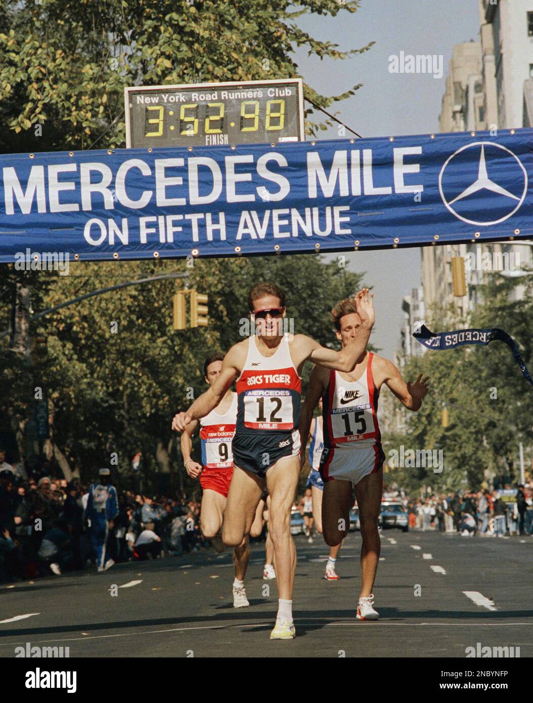 The American record holder in the mile, Steve Scott, crosses the finish ...