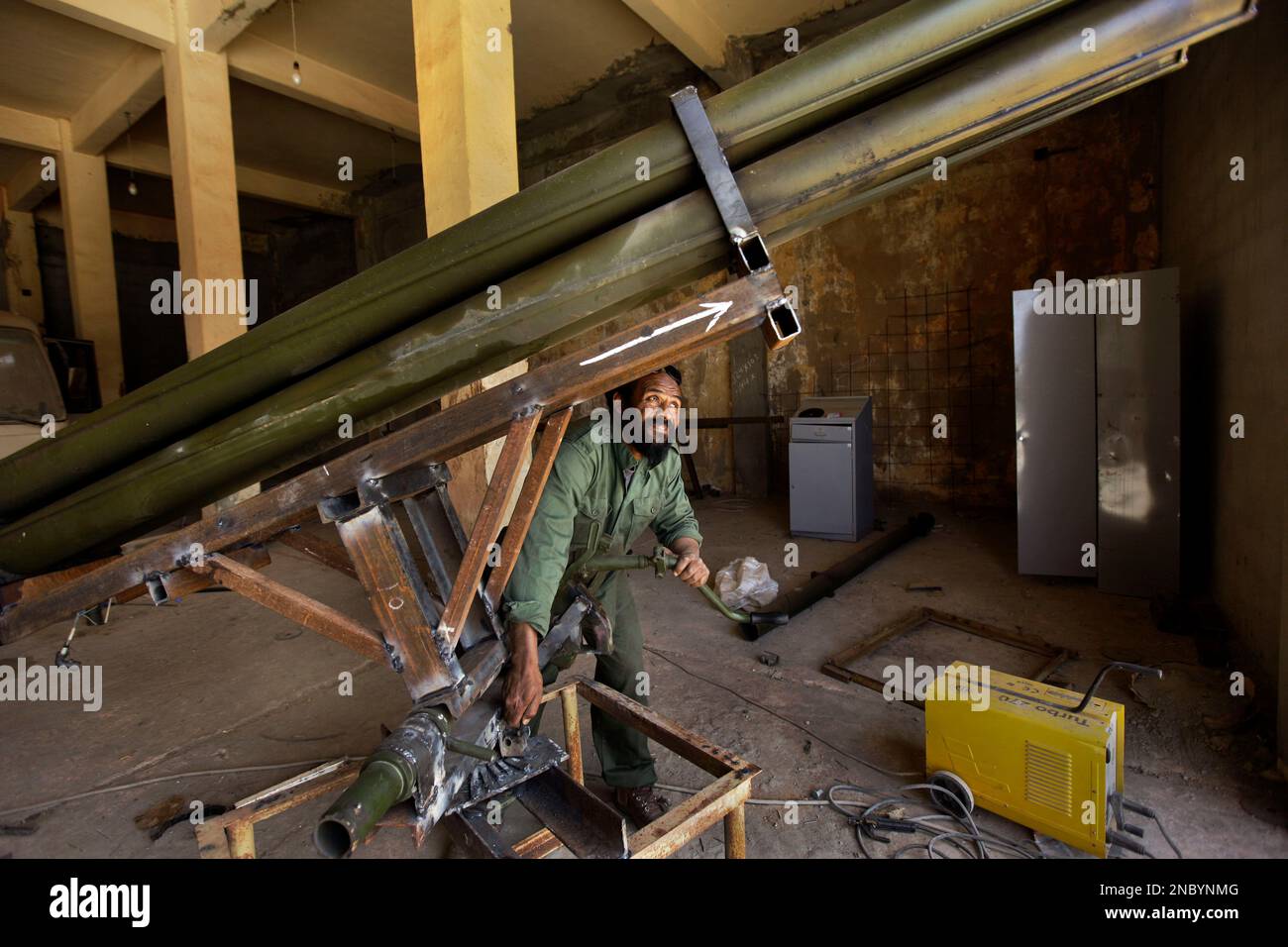 A welder works at making a Grad rocket launcher operational, at a ...