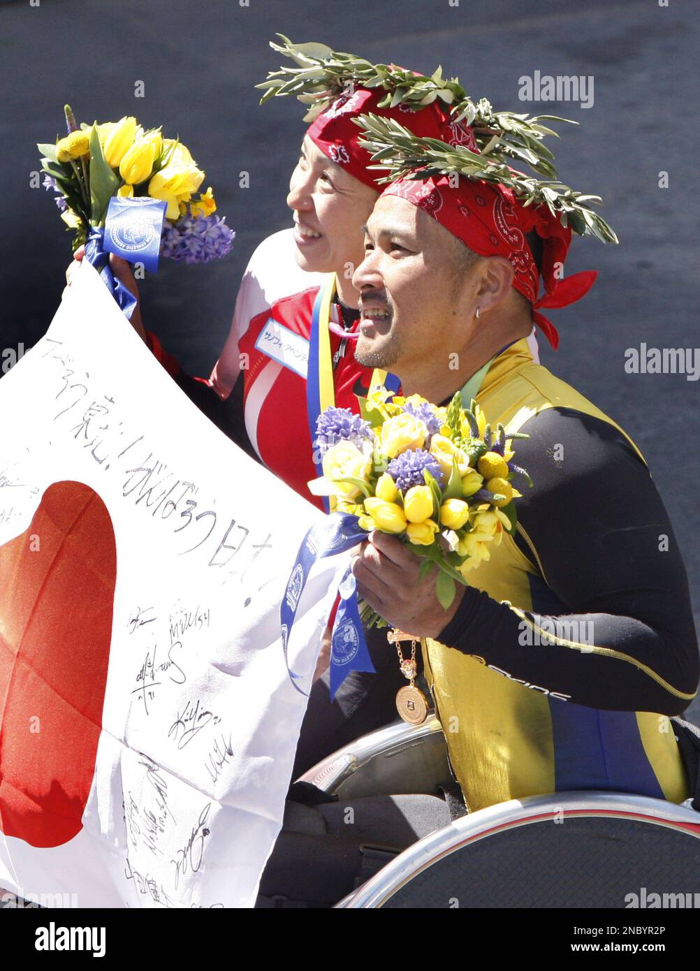 Wheelchair division winners Wakako Tsuchida, left, and Masazumi Soejima, both of Japan, together ...