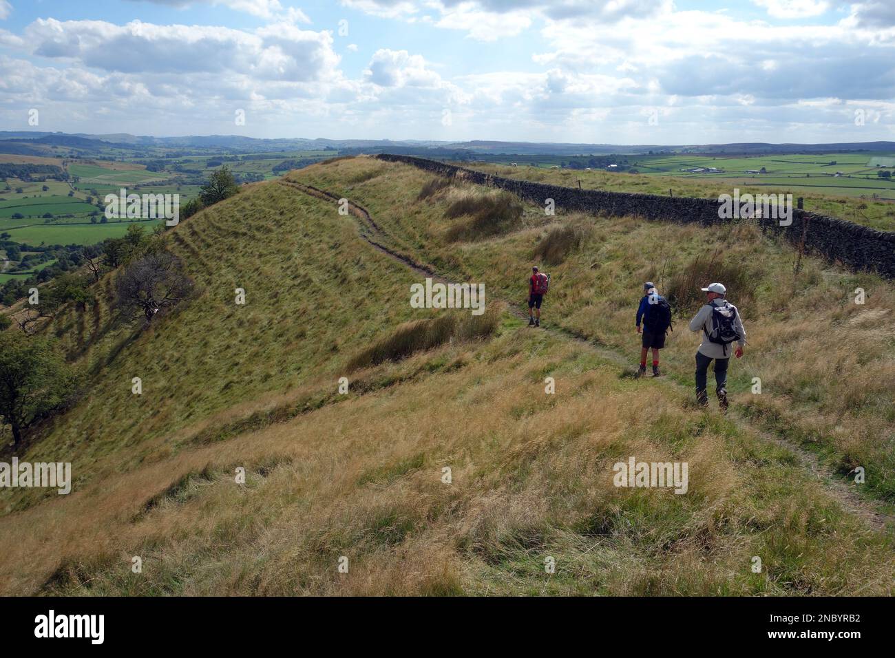 Three Men Walking on the Ridge Path on Hollins Hill by a Stone Wall in ...
