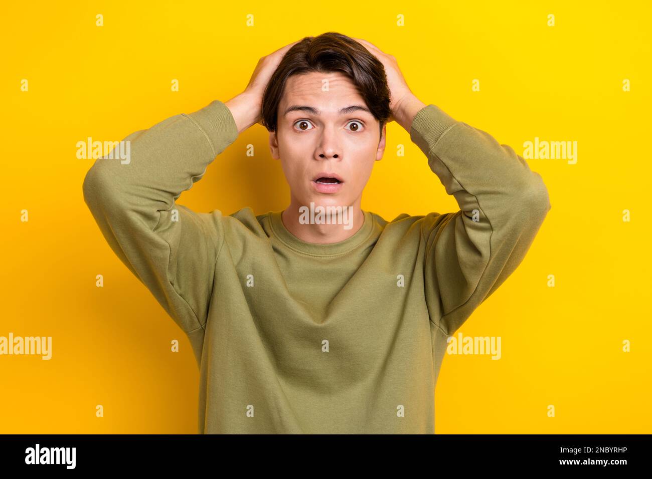 Photo of impressed young man arms touch head open mouth cant believe ...