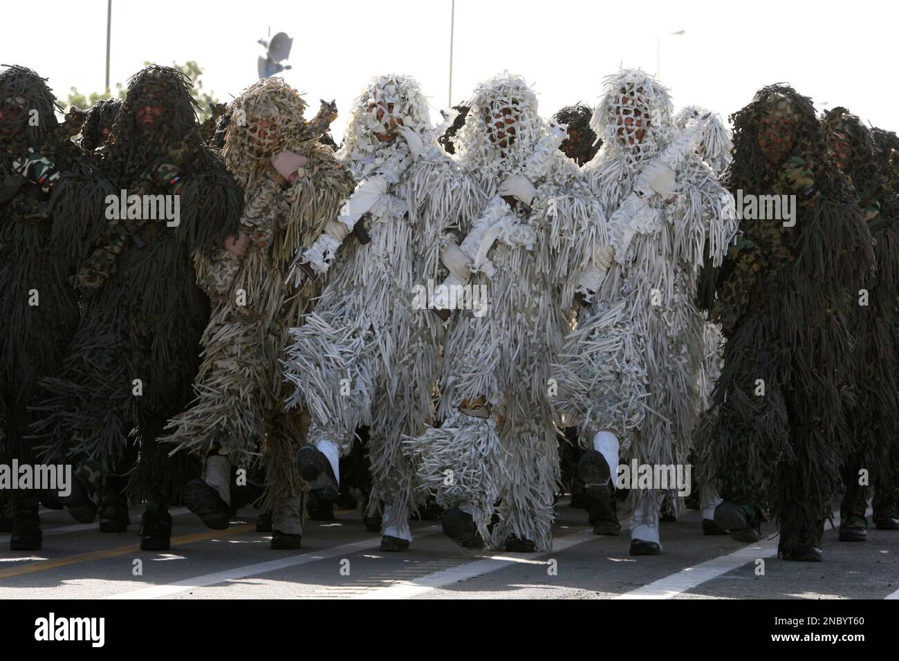 Wearing ghillie suits, Iranian army troops, march during a parade, marking national Army Day in ...
