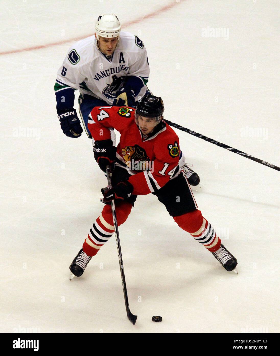 Chicago Blackhawks' Chris Campoli(14) looks to a pass past Vancouver ...