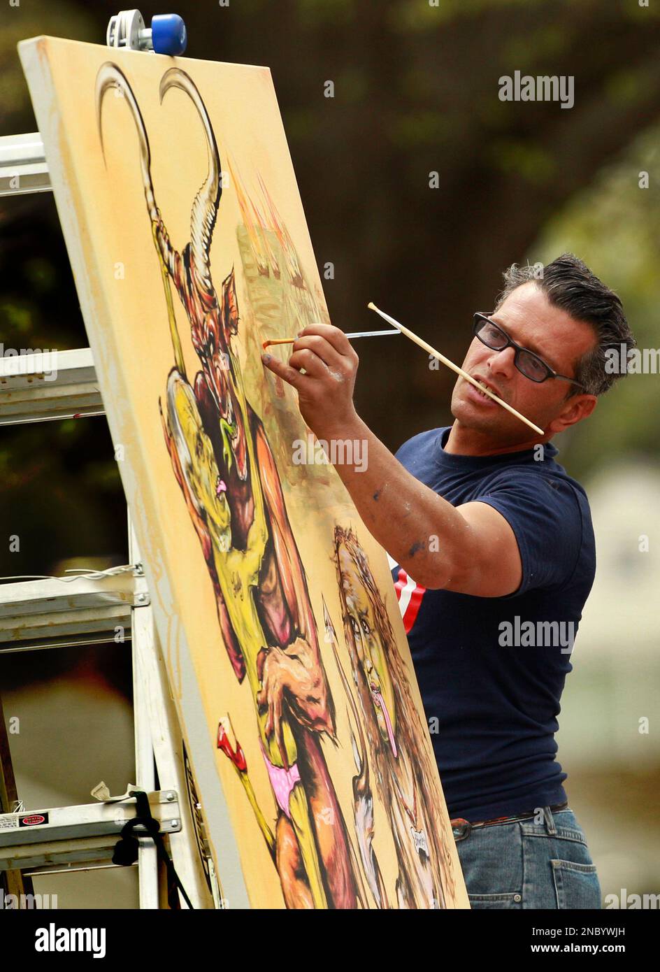 New York City artist Scott LoBaido works on his painting of famed ...