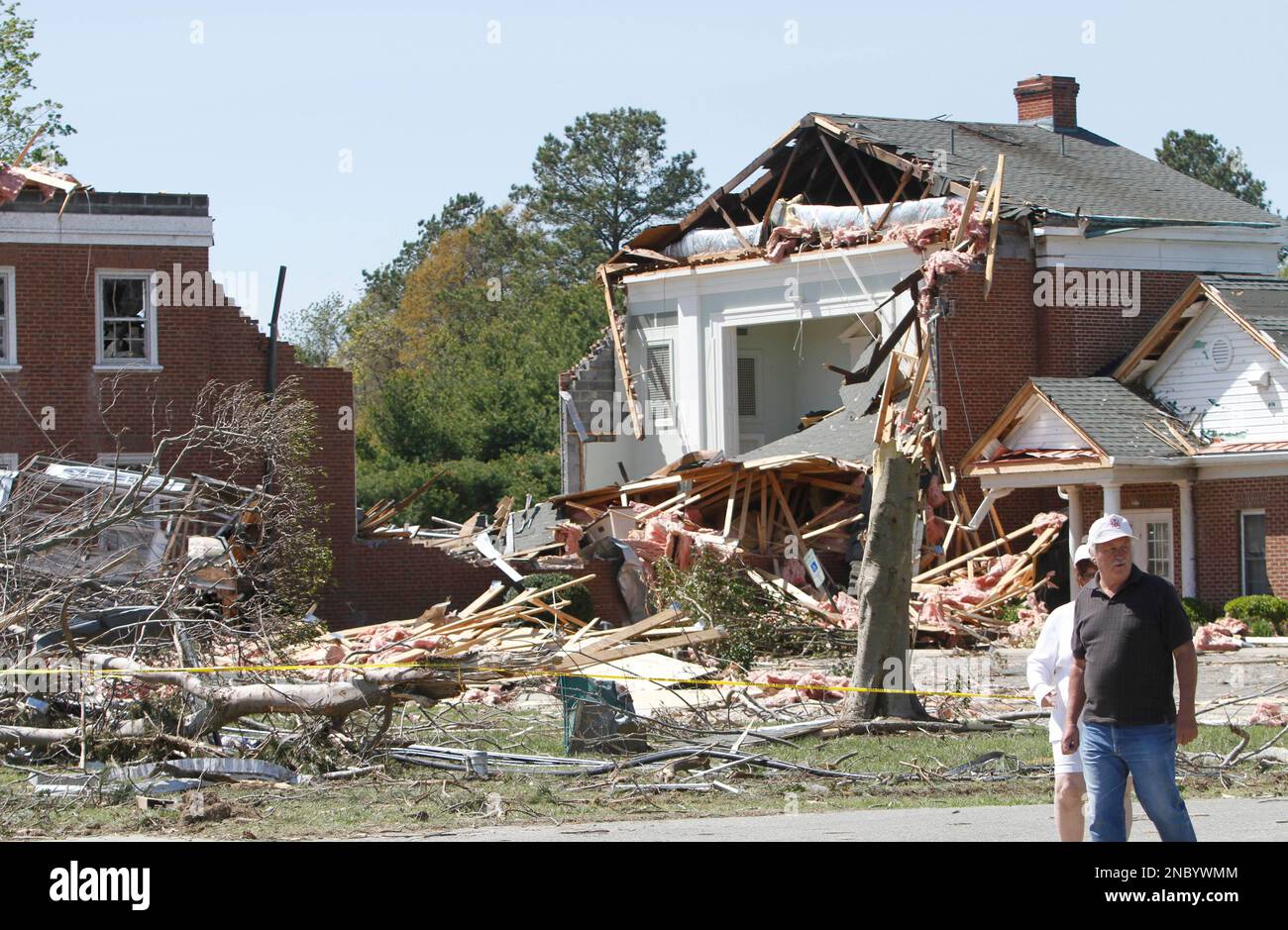 Onlookers walk buy the remains of a destroyed church damaged after a ...