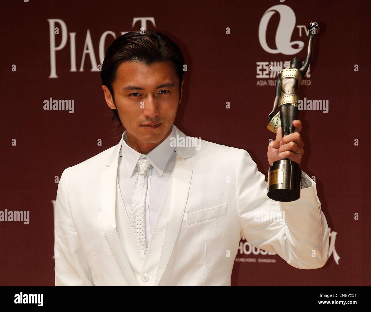 Hong Kong actor Nicholas Tse displays his trophy after winning Best ...
