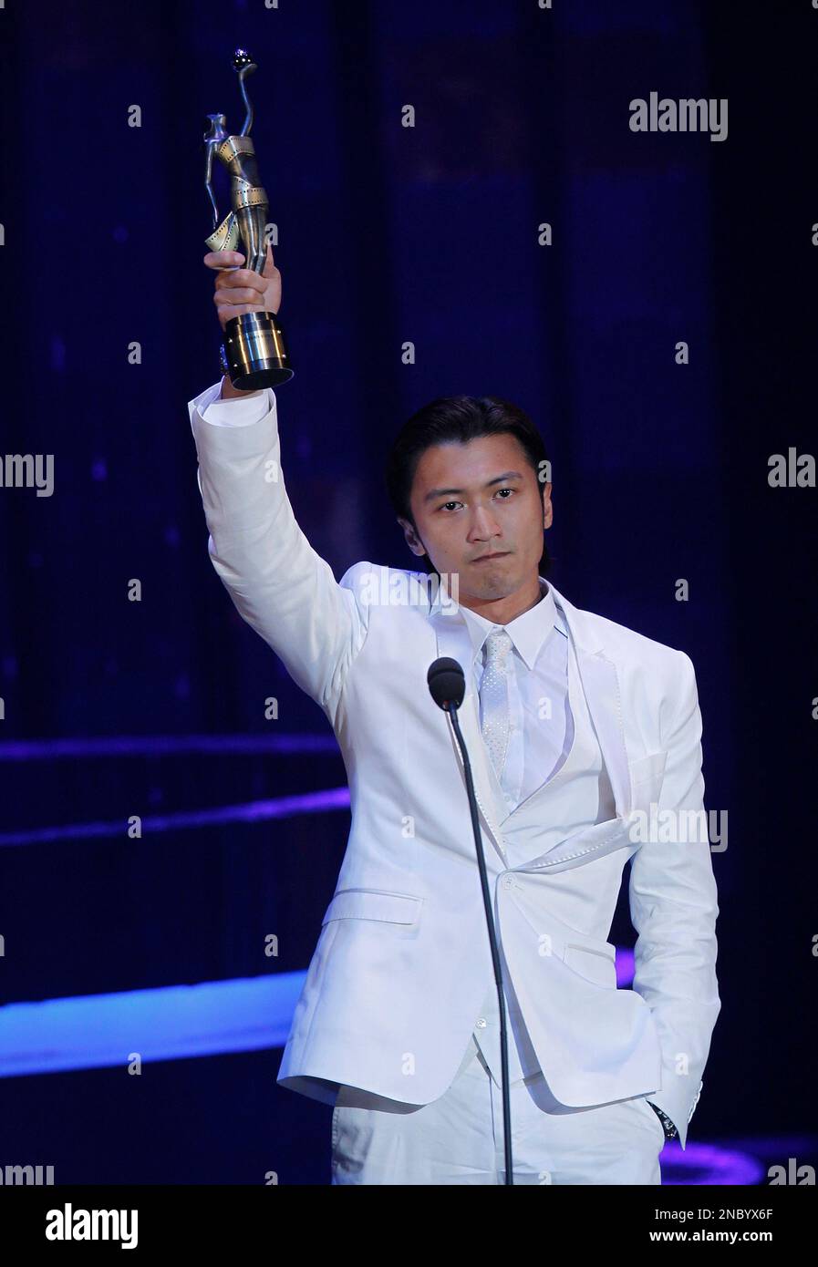 Hong Kong actor Nicholas Tse celebrates with the trophy after winning ...