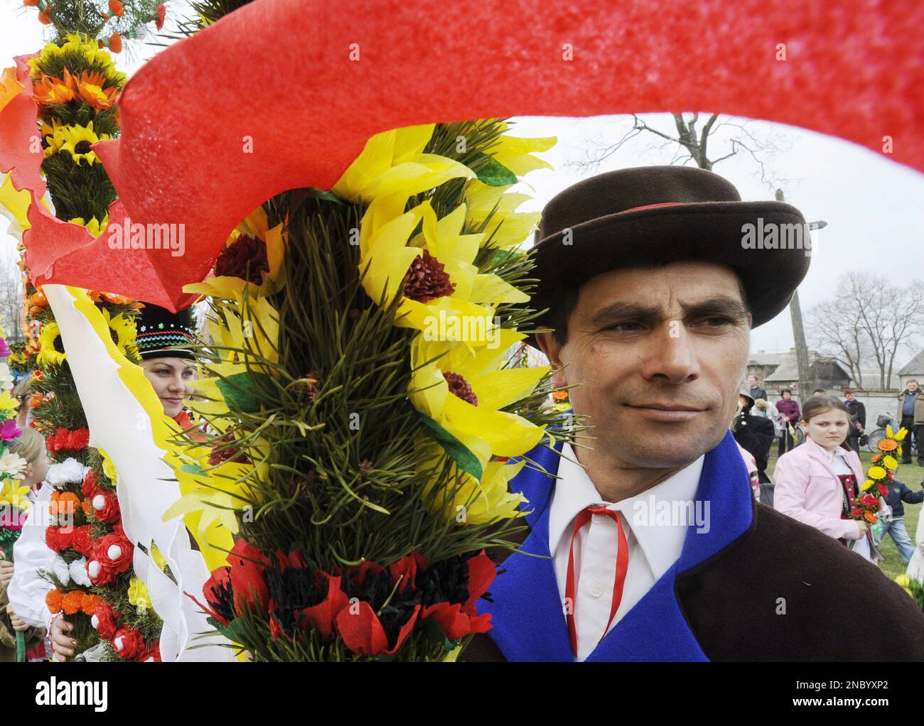 Traditional dressed people carry hand made palms during a Palm Sunday ...