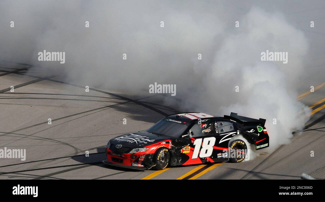 Nationwide driver Kyle Busch (18) celebrates his win in the Aaron's 312 ...