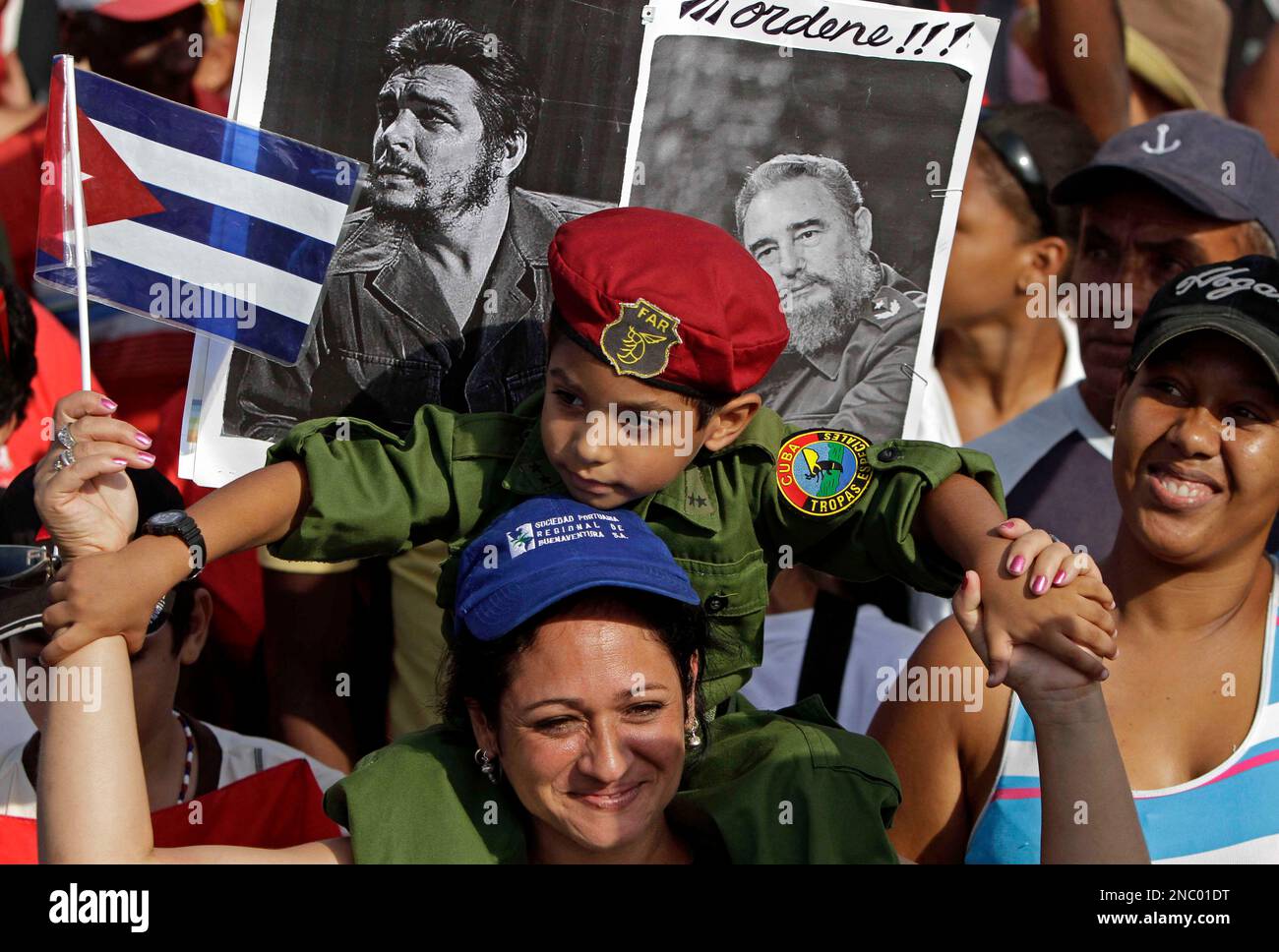 A boy dressed as a Cuban soldier and his mother attend the parade ...