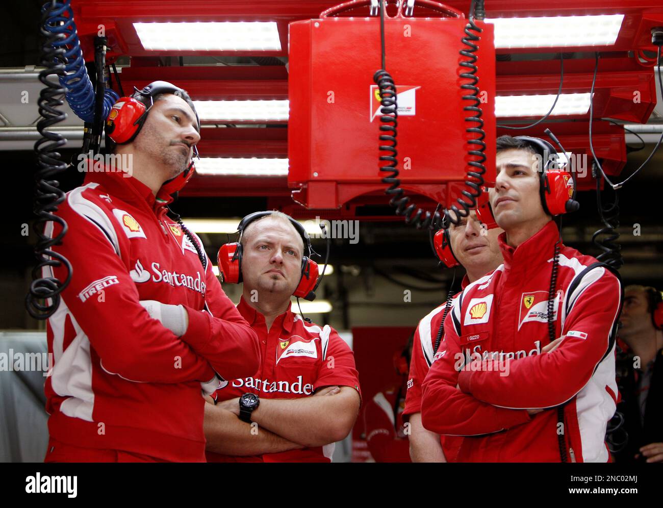 Ferrari mechanics watch their screens as their drivers compete in the ...