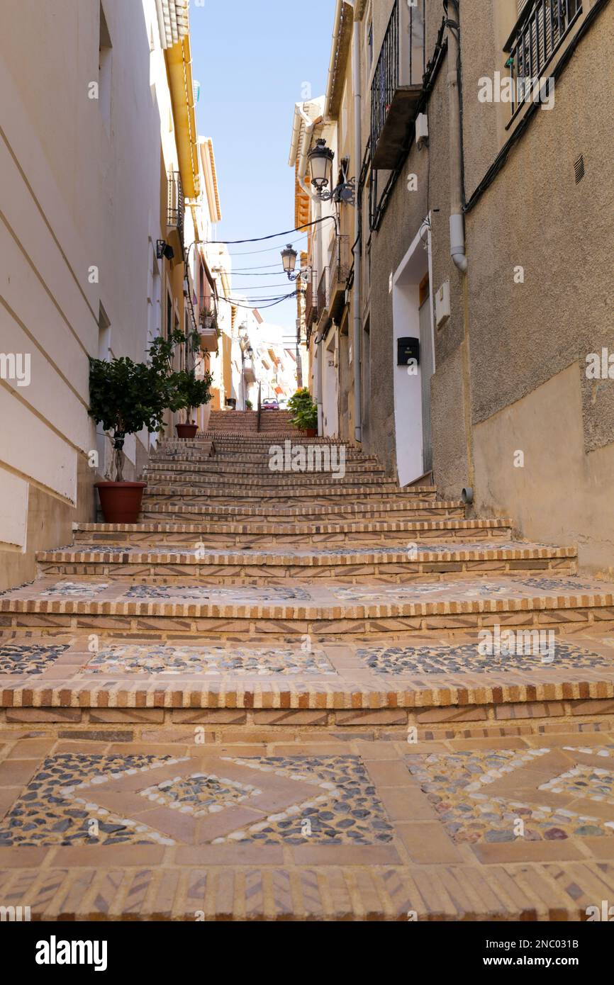 Relleu, Alicante, Spain- February 5, 2023: Narrow pebbled street and ...
