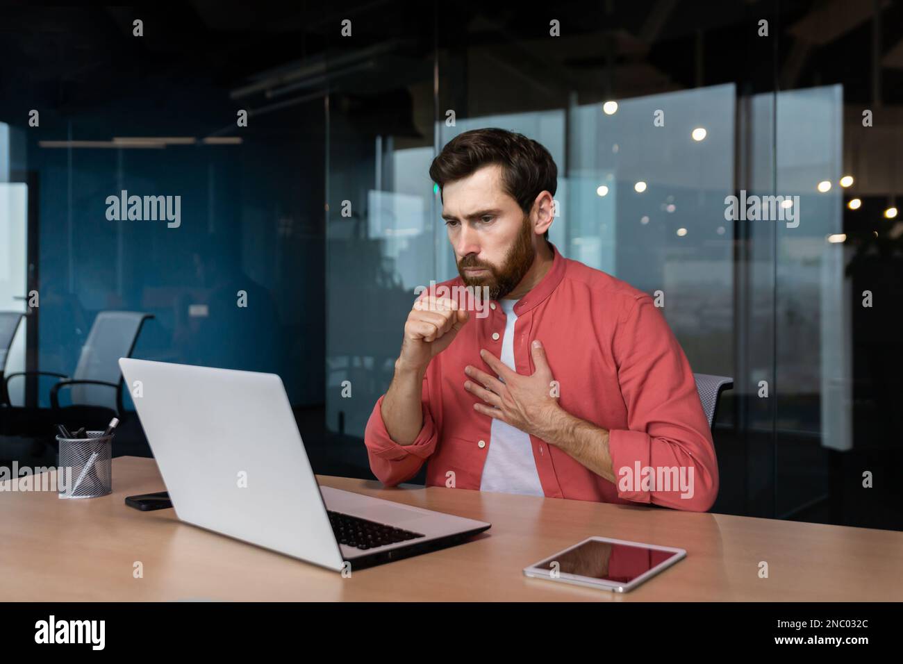 Sick man at workplace, mature worker in red shirt coughing, businessman ...