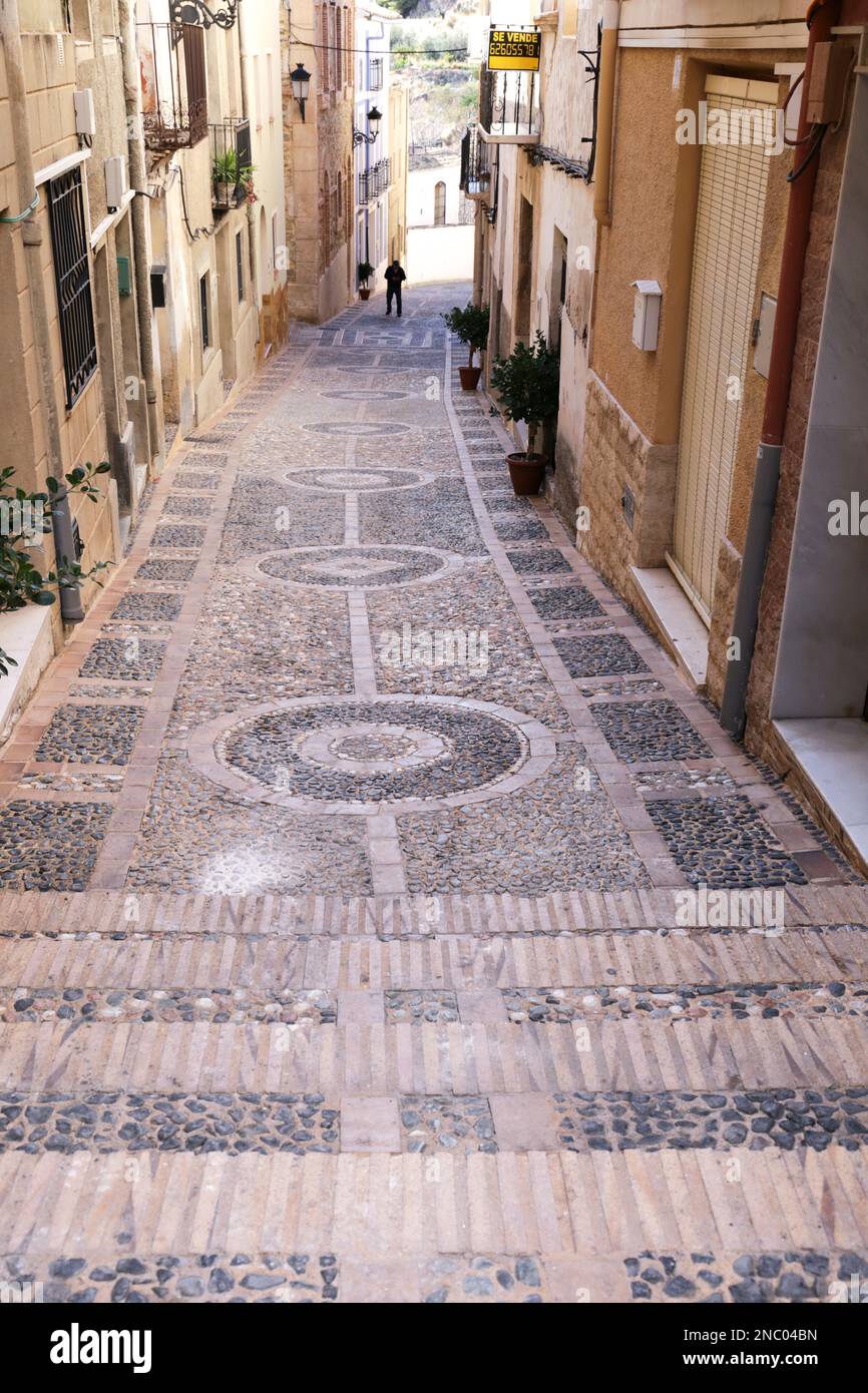 Relleu, Alicante, Spain- February 5, 2023: Narrow pebbled street and ...