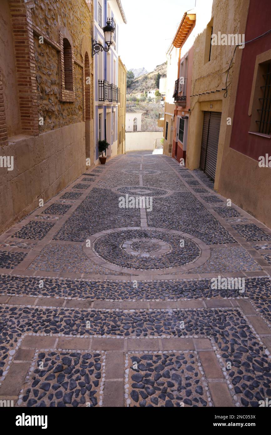 Relleu, Alicante, Spain- February 5, 2023: Narrow pebbled street and ...
