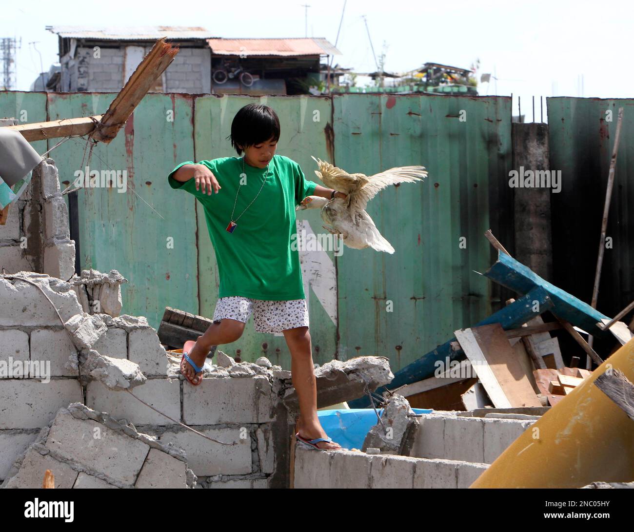 A boy saves a duck from the rubble as demolition tear down their ...