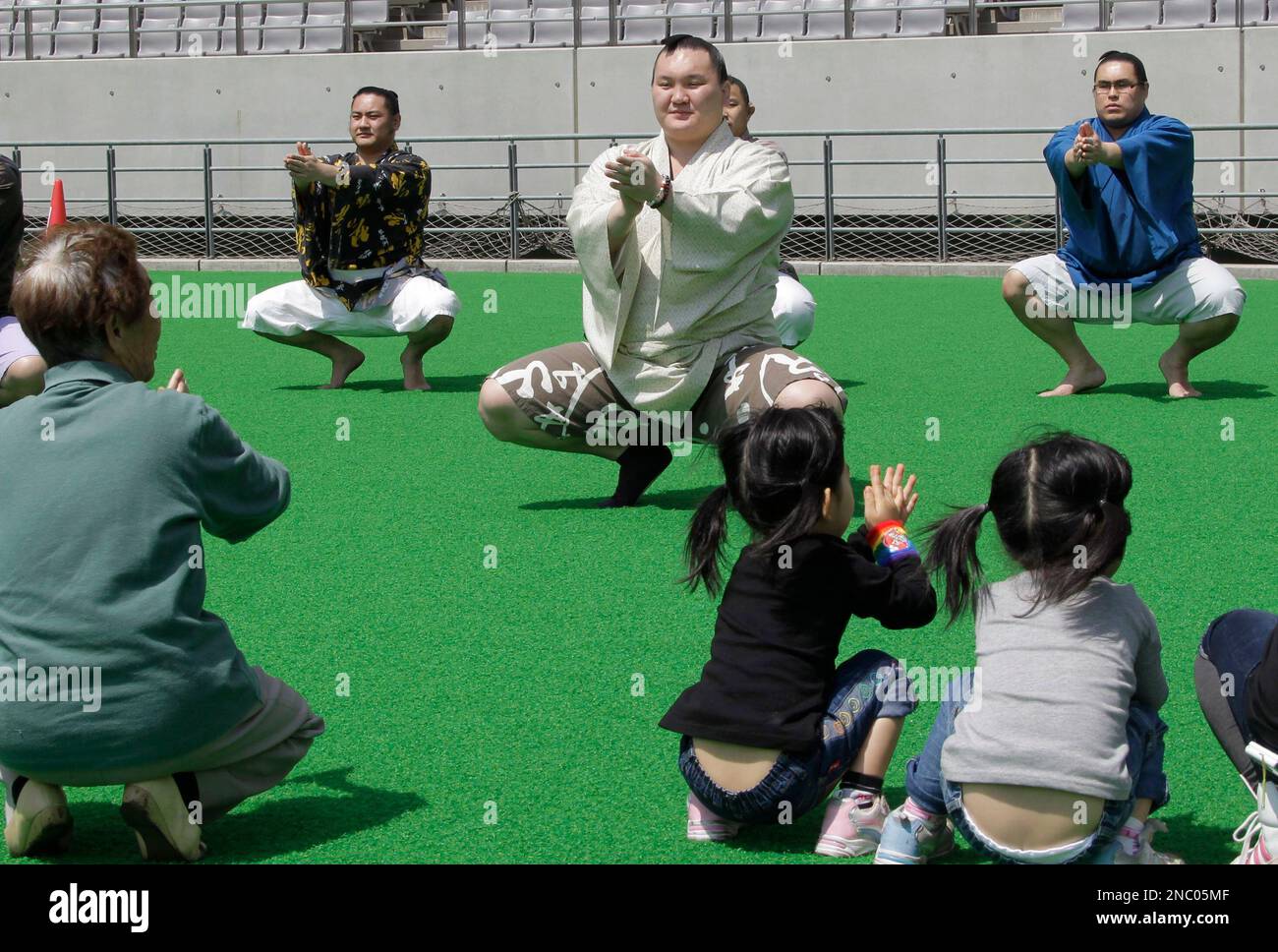 Mongolian sumo grand champion Hakuho, center, and other wrestlers ...
