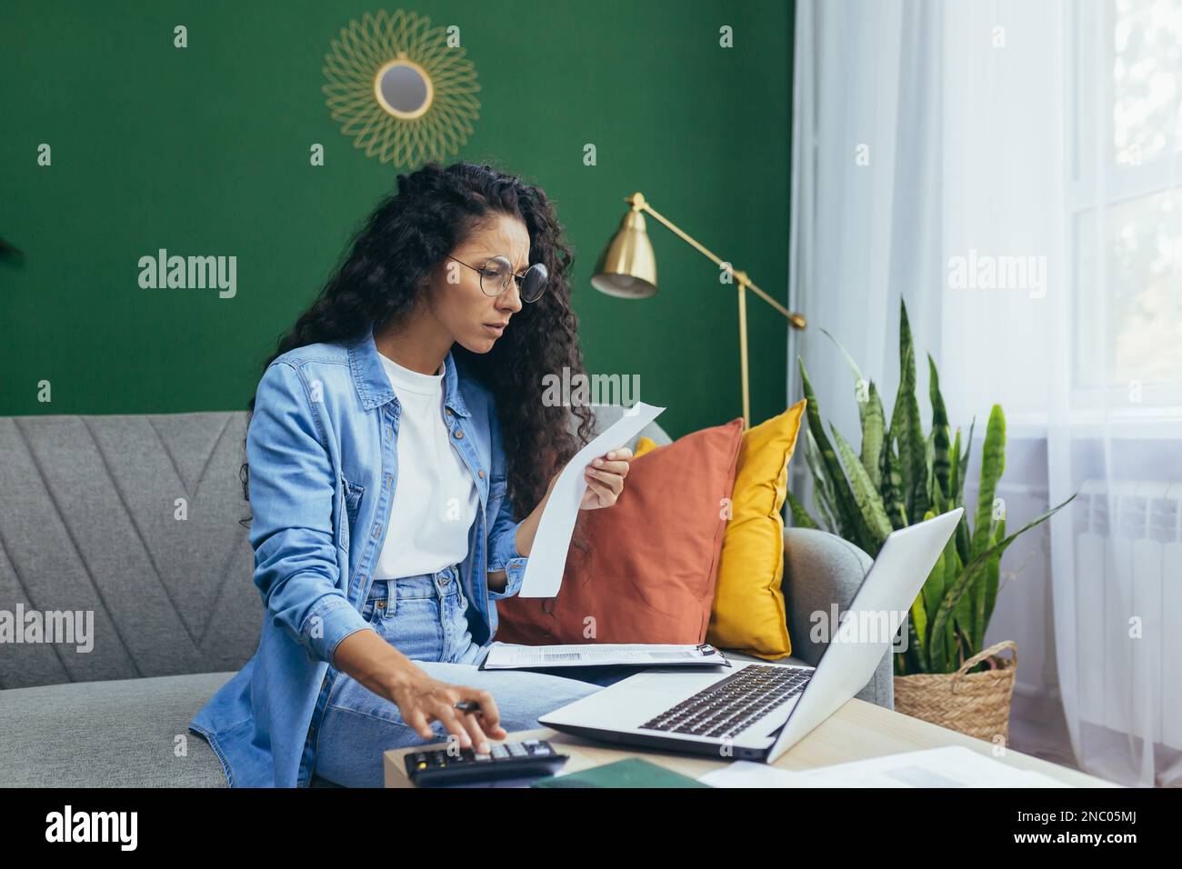 Indian woman checks paper bills hi-res stock photography and images - Alamy