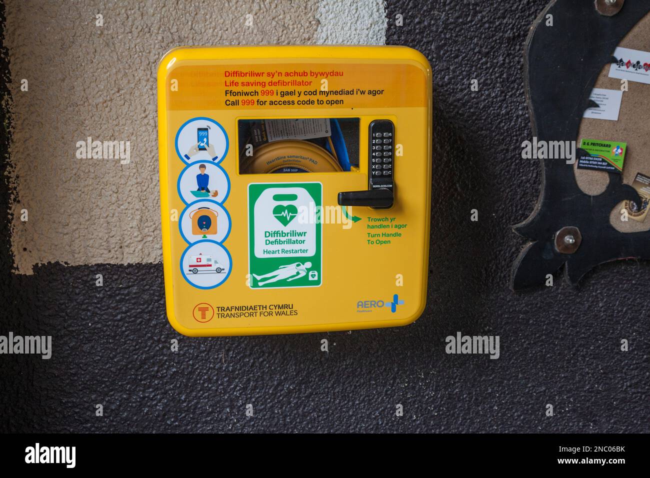 A defibrillator on the wall at the shops in the picturesque village of ...