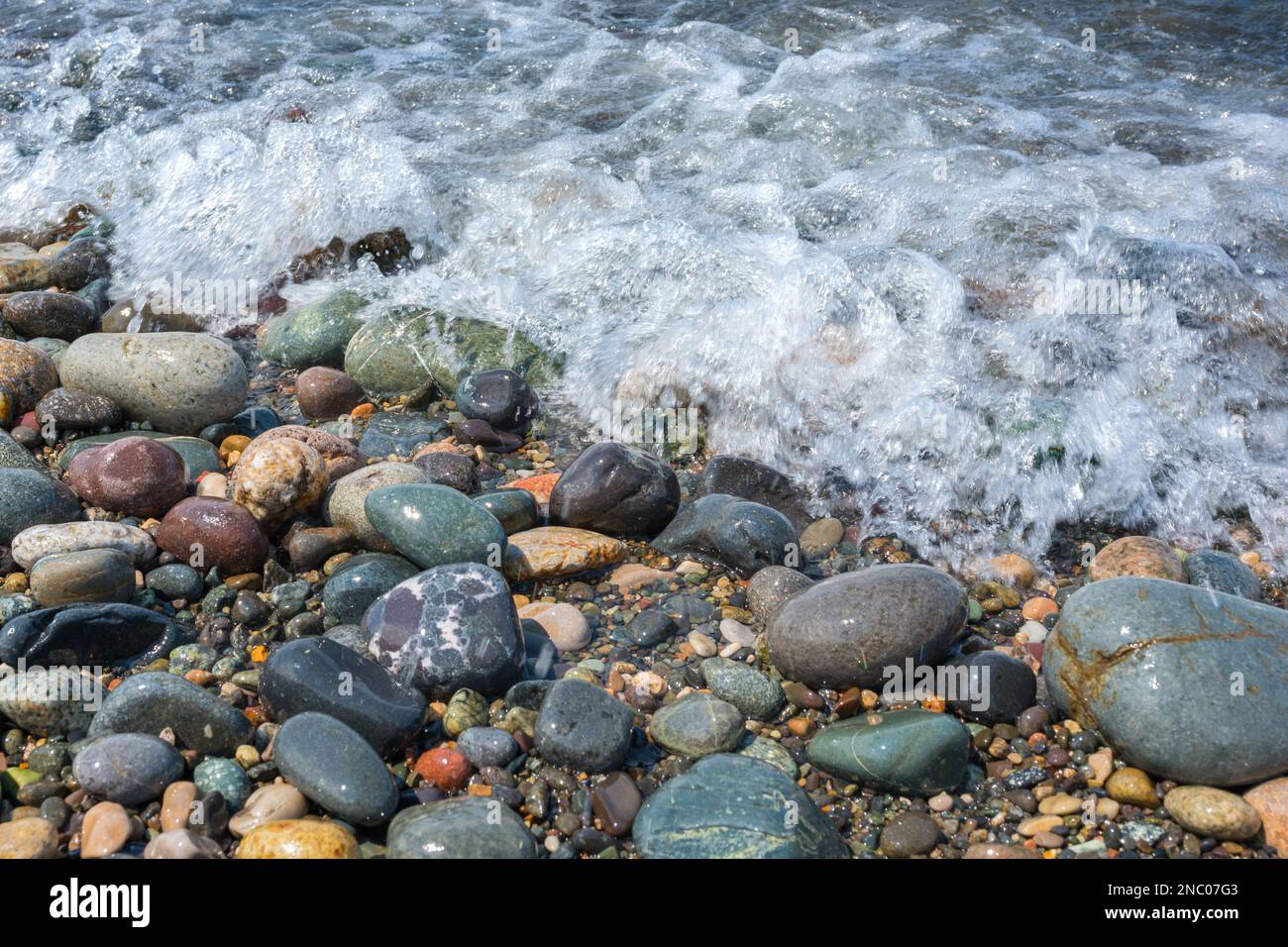 Colored pebbles on the seashore Stock Photo - Alamy