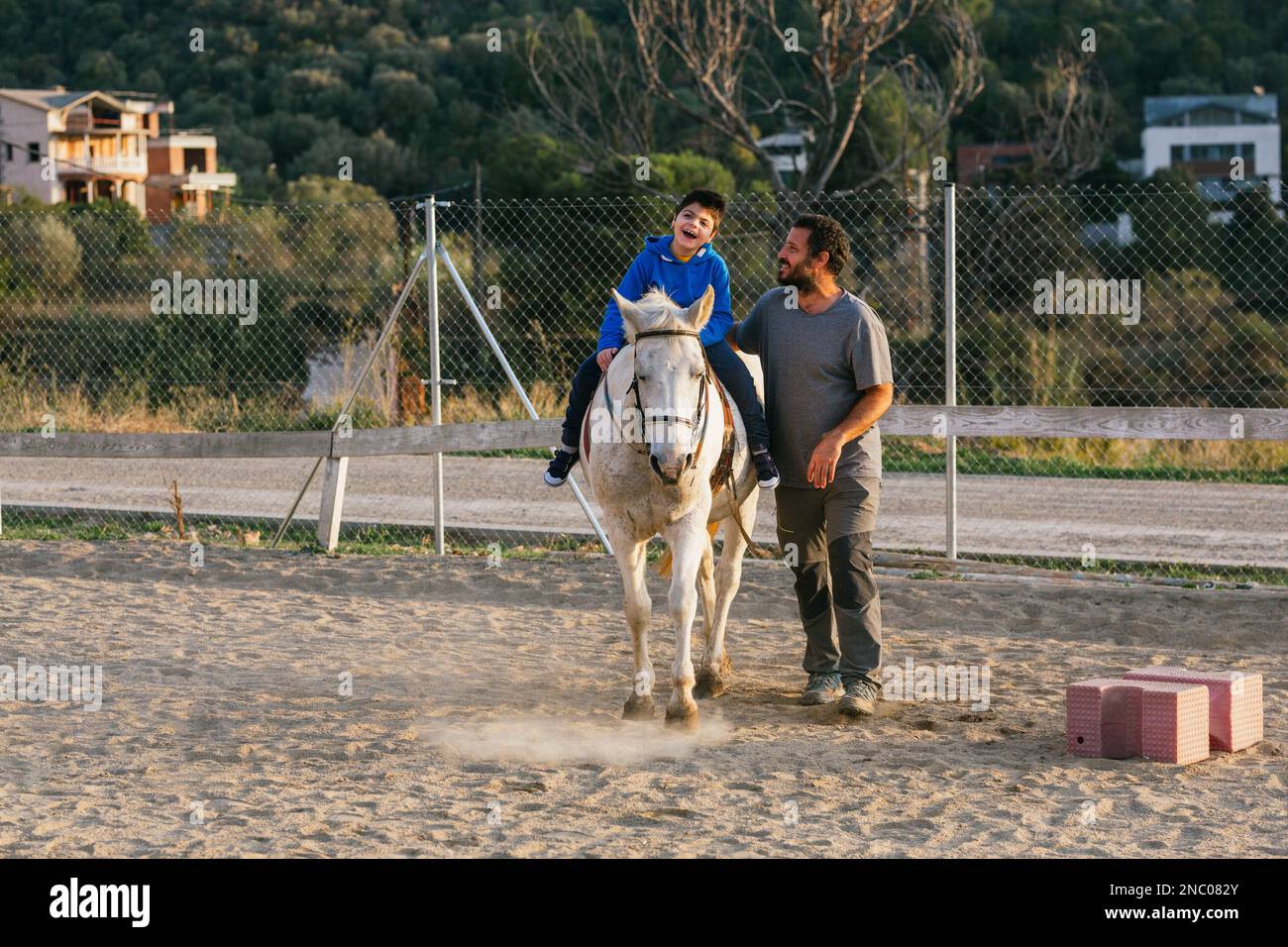 Child with disabilities riding a horse in an equine therapy session at ...