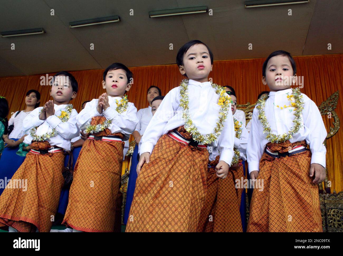 Myanmar boys in traditional costumes wait to perform a dance in celebration of Myanmar's ...