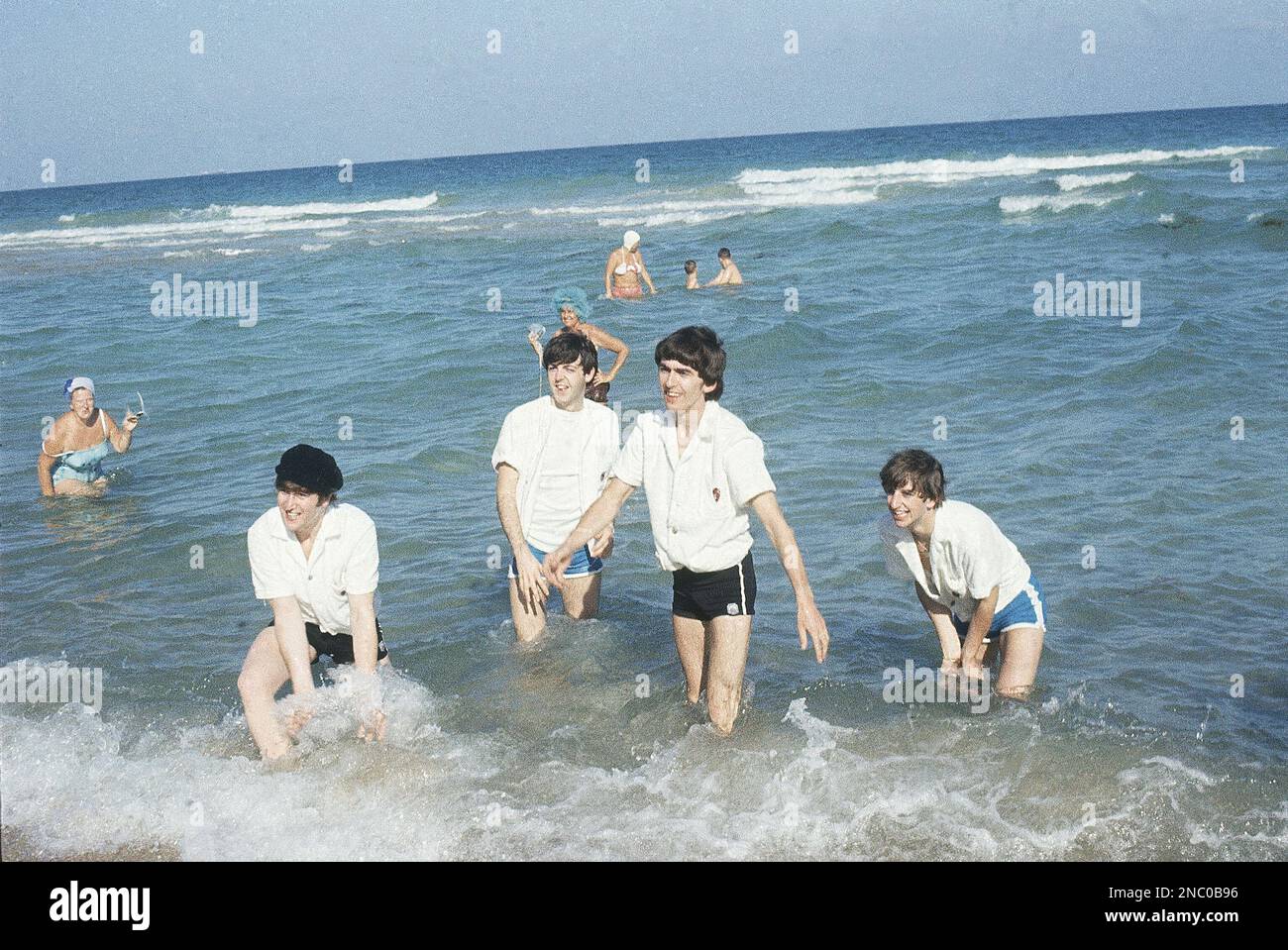The Beatles wade in the surf on the beach in Miami, Florida in February ...