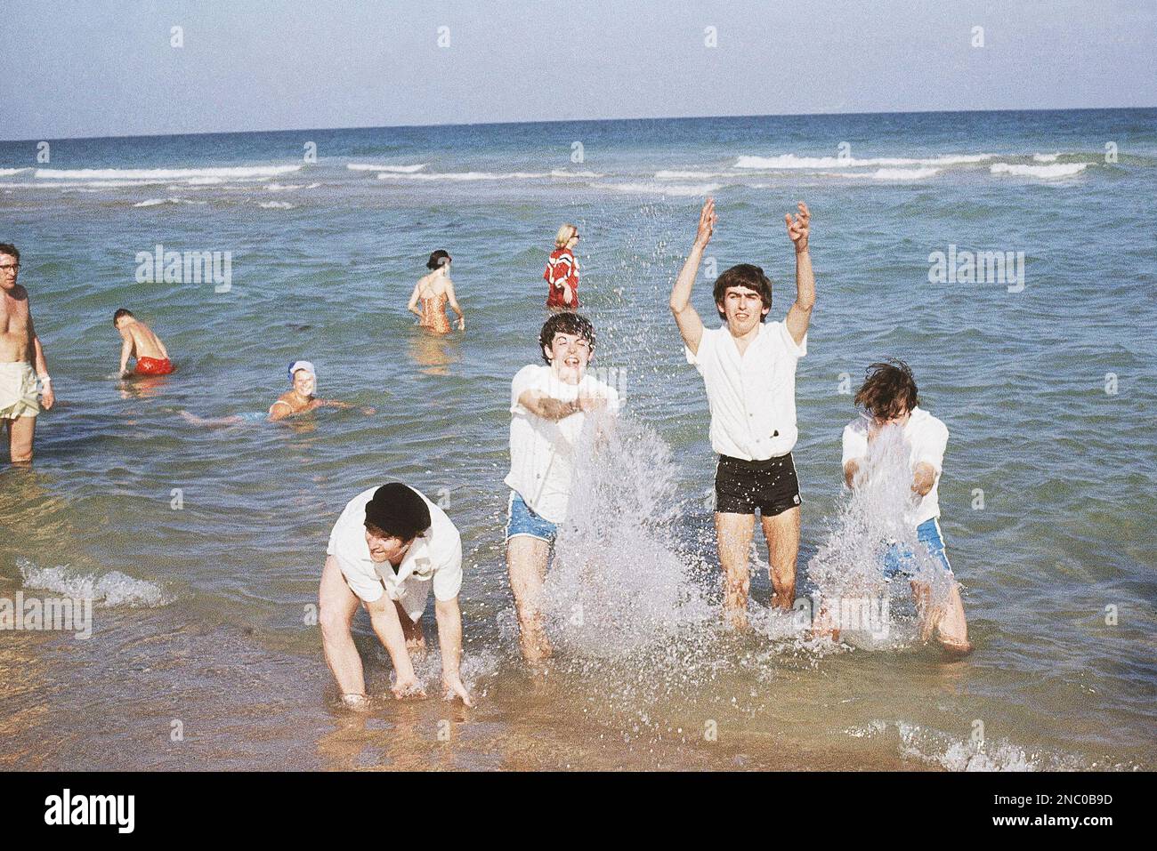 The Beatles splash around in the surf at Miami, Florida in February ...