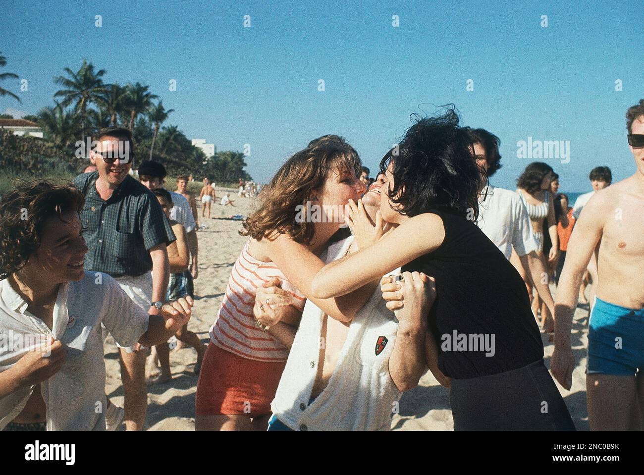 Beatles drummer Ringo Starr is mobbed by fans on the beach in Nassau ...