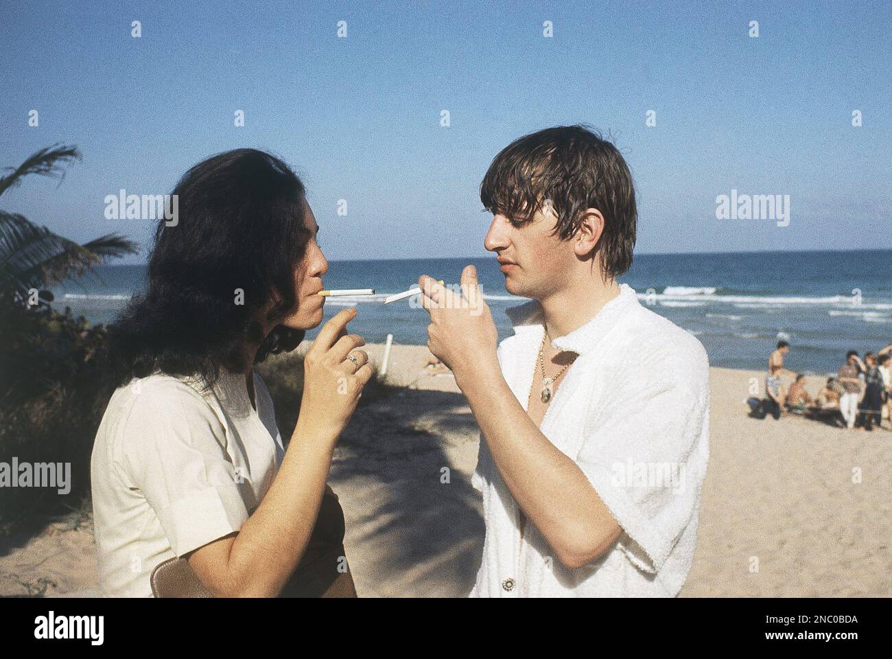 Ringo Starr of the Beatles gives an unidentified person a light at the ...