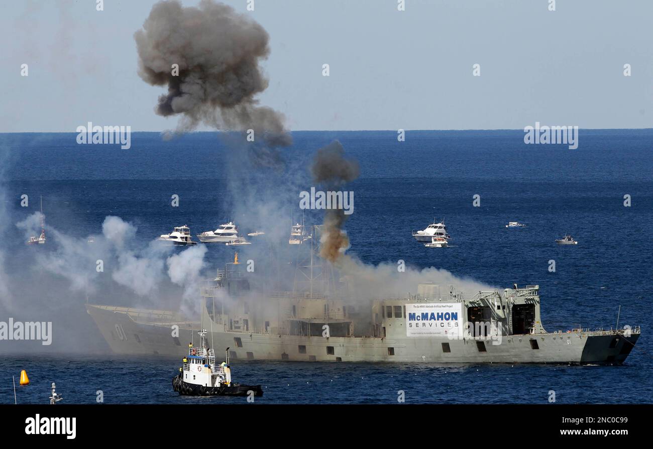Smoke pours out of the Ex-HMAS Adelaide, a decommissioned RAN warship ...