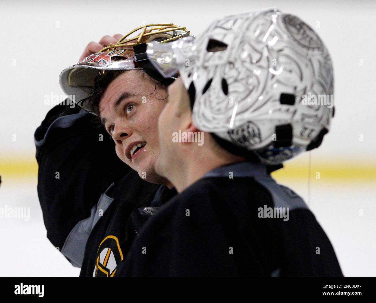 Boston Bruins goalie Tuuka Rask takes off his mask as he rests at ...