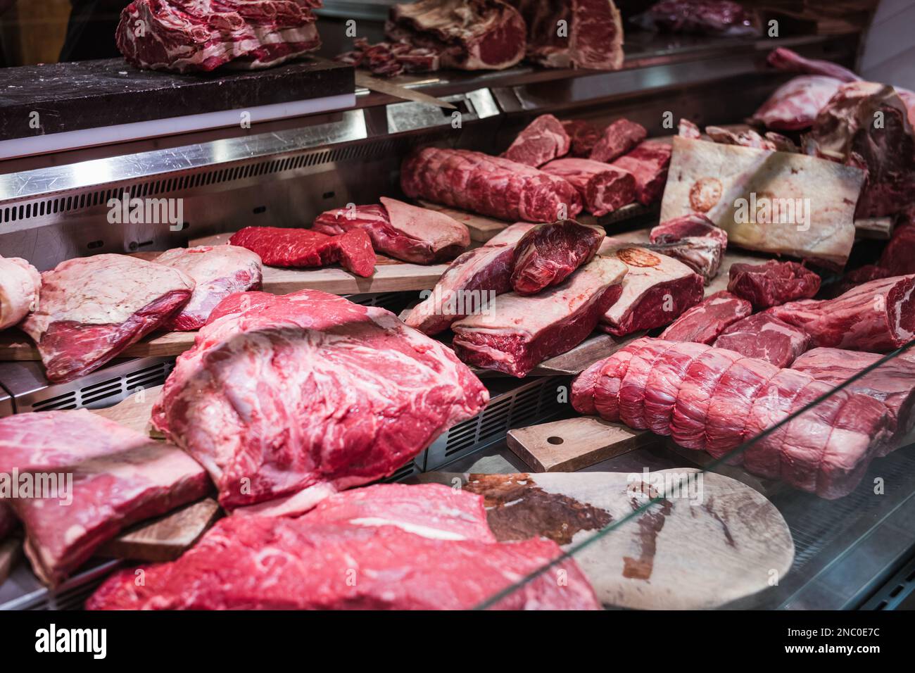 Selection of fresh raw beef and meat in a display counter at the ...