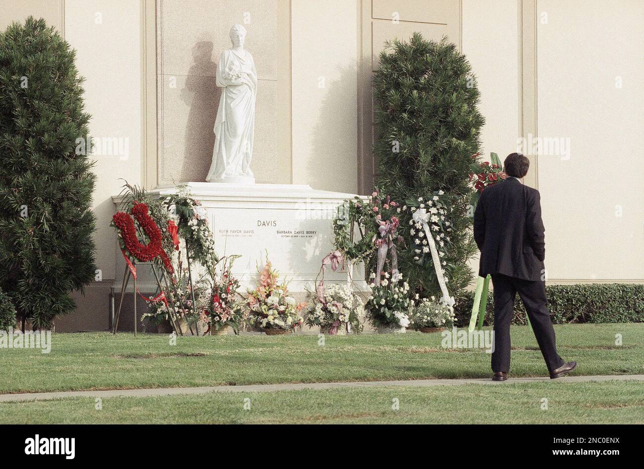 An unidentified passerby looks at the family sarcophagus of actress ...
