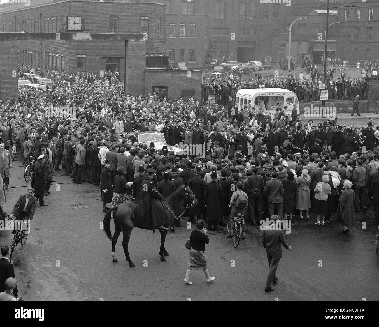 Factory workers crowd round the car as Major Yuri Gagarin, the Russian ...