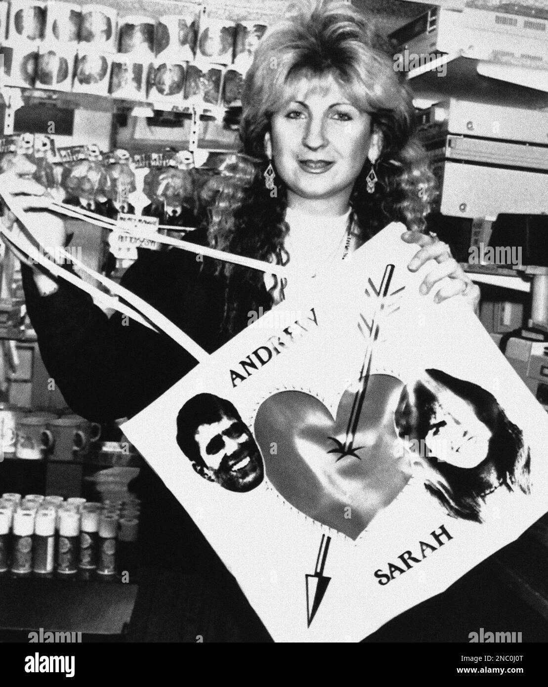 Ann Pierre holds up one of the many Royal Wedding souvenirs on sale ...