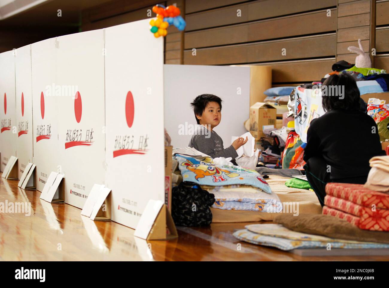 Ryosuke Fujita, 9, talks with his aunt Noriko Tanabe at an evacuation center in Fukushima ...