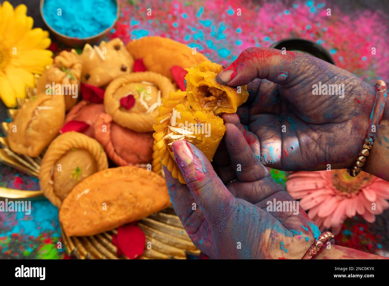 Hands Of A Girl Painted With Colorful Gulal Holding Delicious Gujiya ...