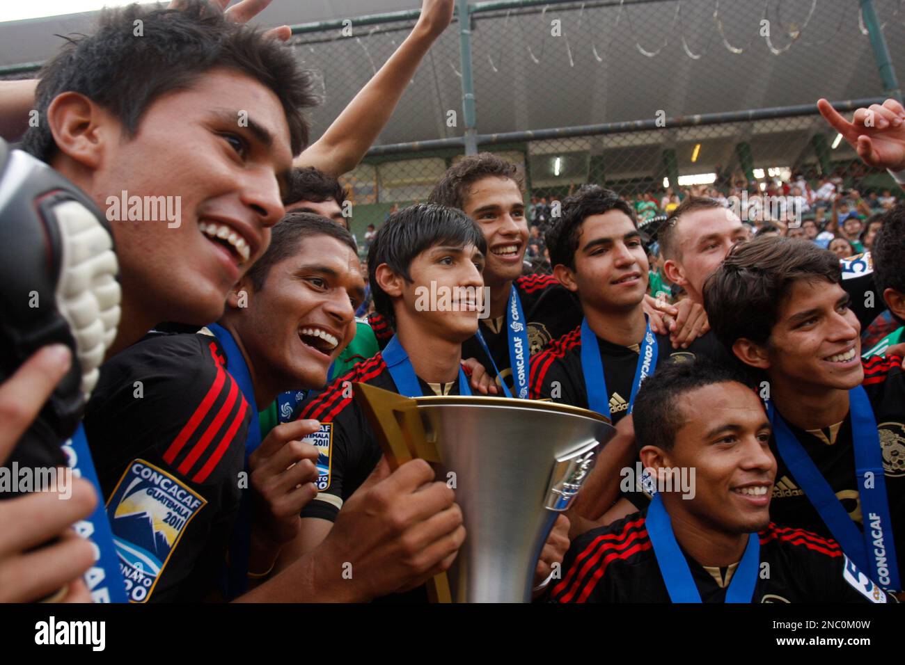 Mexico's U-20 soccer players pose for photos with their trophy after ...