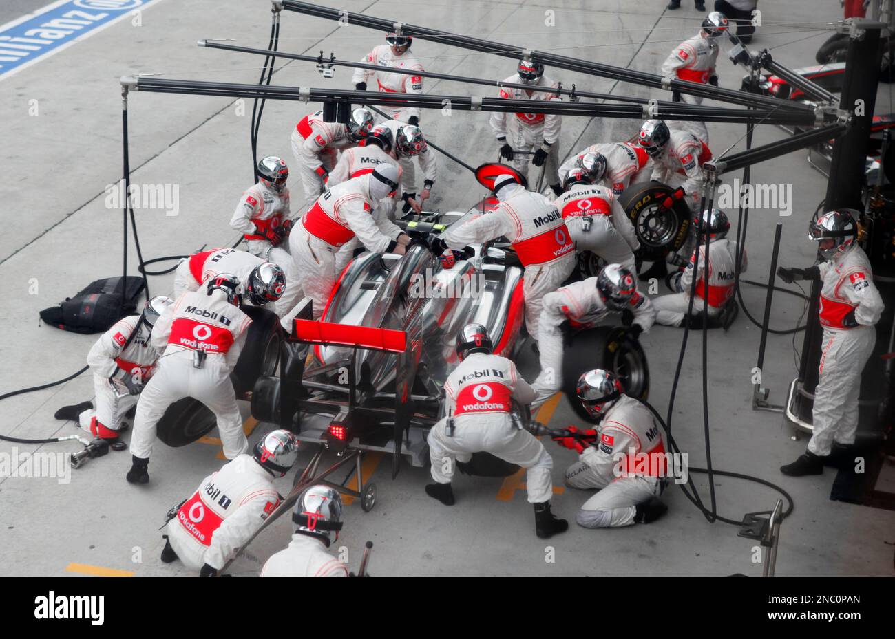 McLaren Formula One driver Jenson Button of Britain pulls into pit lane ...
