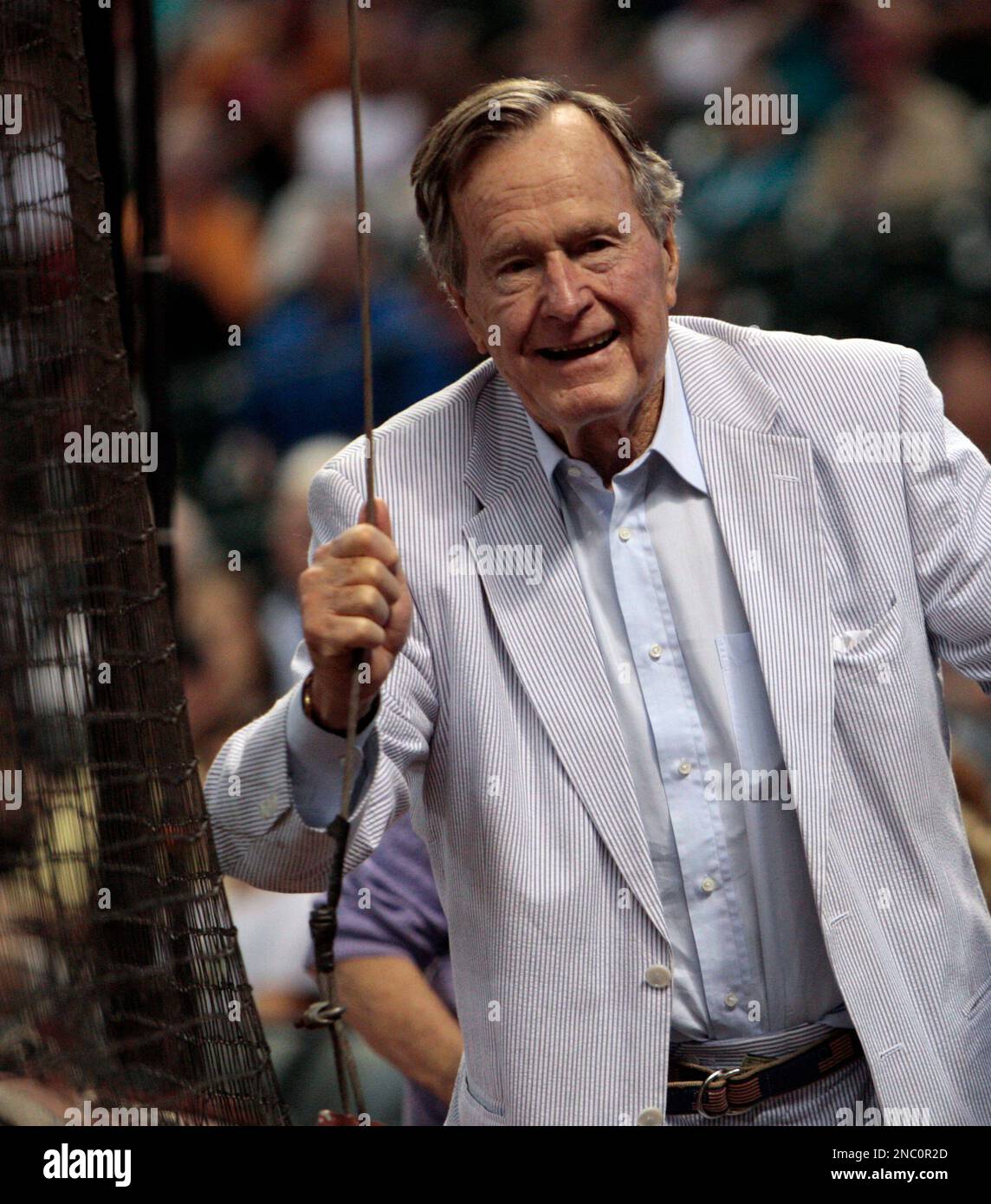 Former United States president George H.W. Bush he leaves the ballpark ...