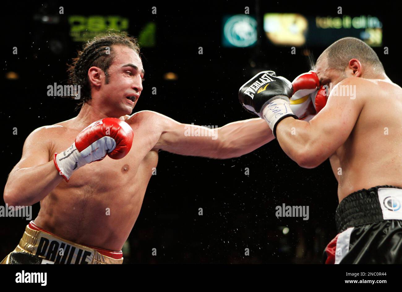 Paulie Malignaggi punches Jose Miguel Cotto, of Puerto Rico during a ...
