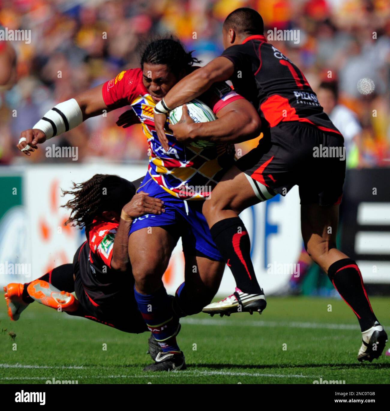 Perpignan's Henry Tuilagi, center, fights for the ball against Toulon's ...