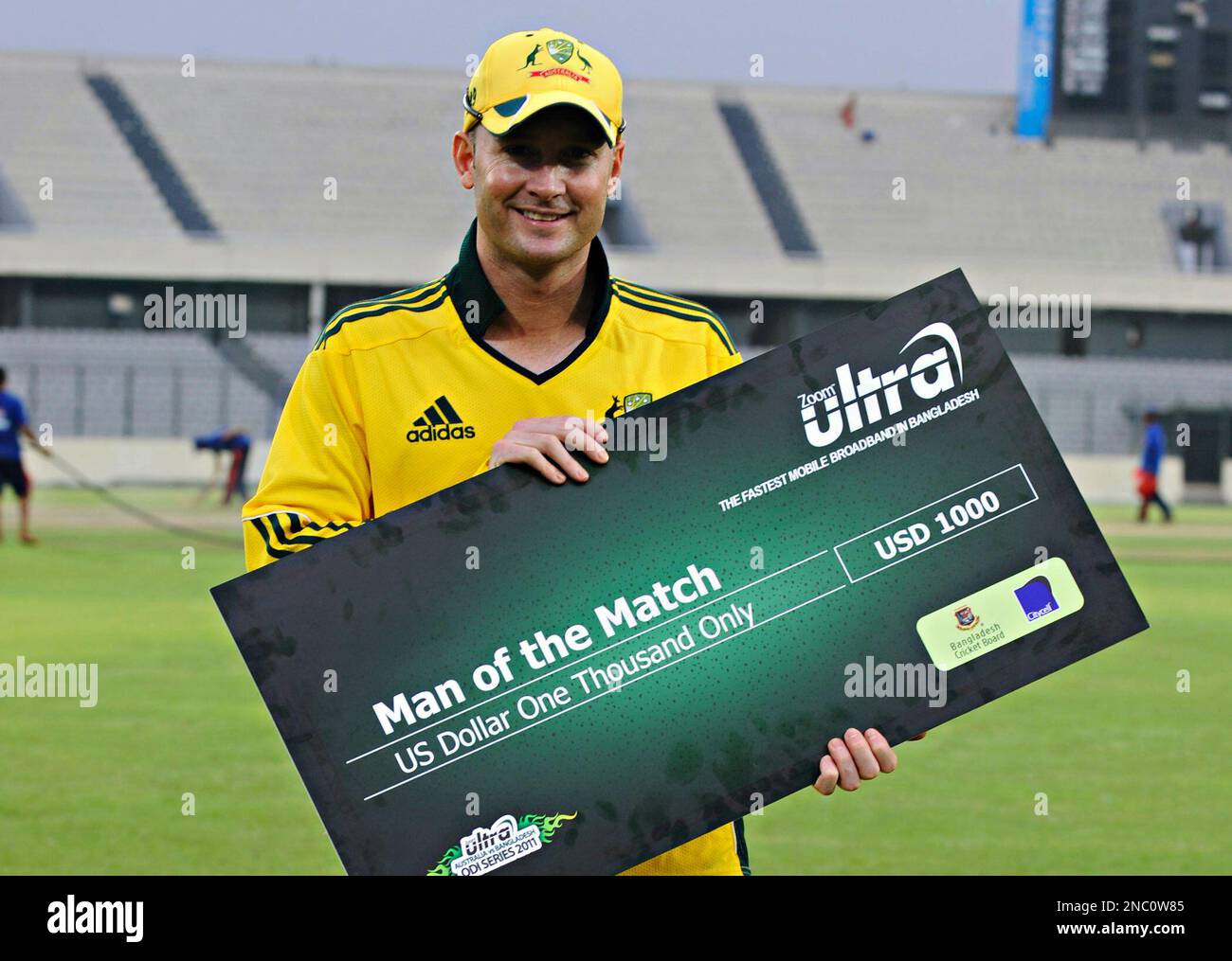 Australian captain Michael Clarke poses with the cheque for being named ...