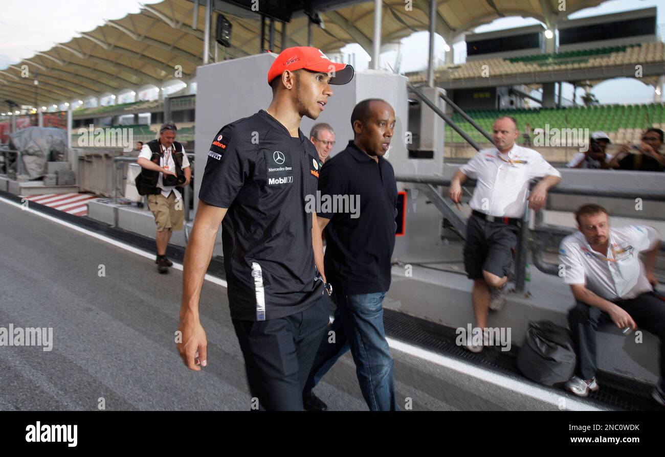 McLaren Formula One driver Lewis Hamilton of Britain chats with his ...