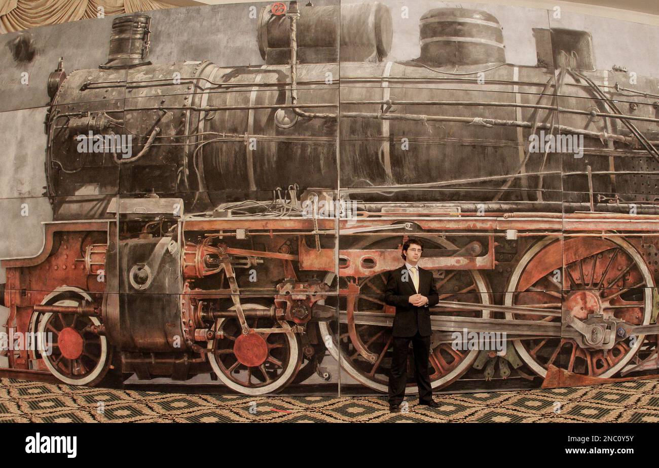 Artist Alexandru Bunescu poses next to his life-size canvas painting ...